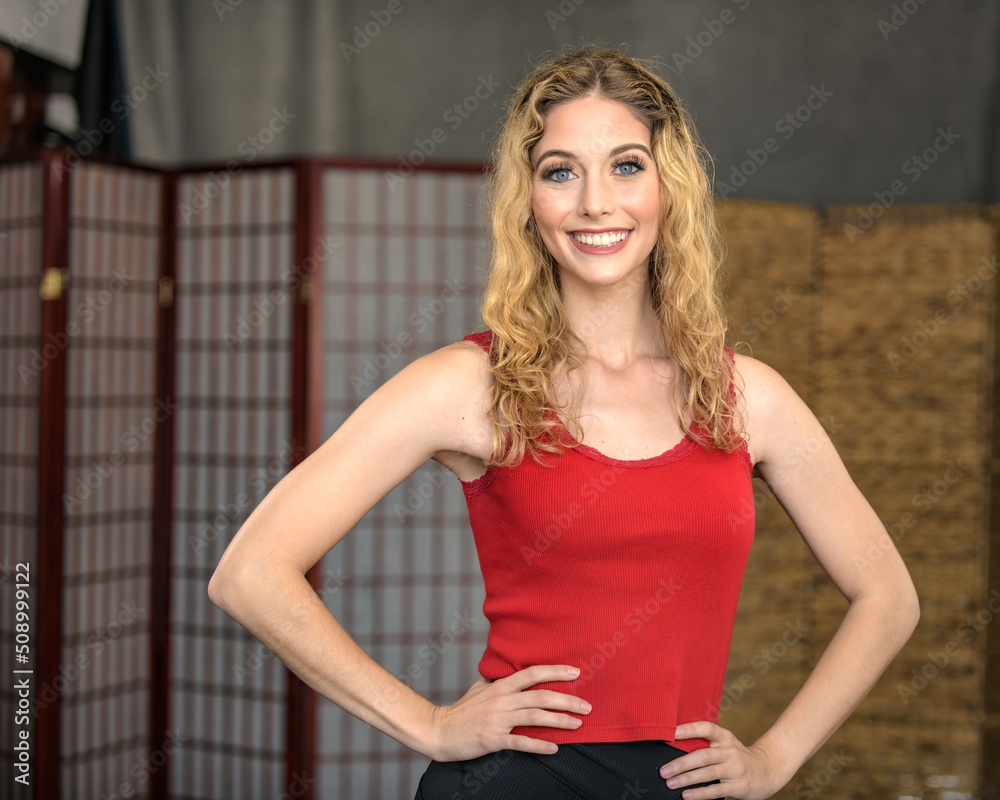 Female Los Angeles athlete with blonde hair and red tank top poses in a ...