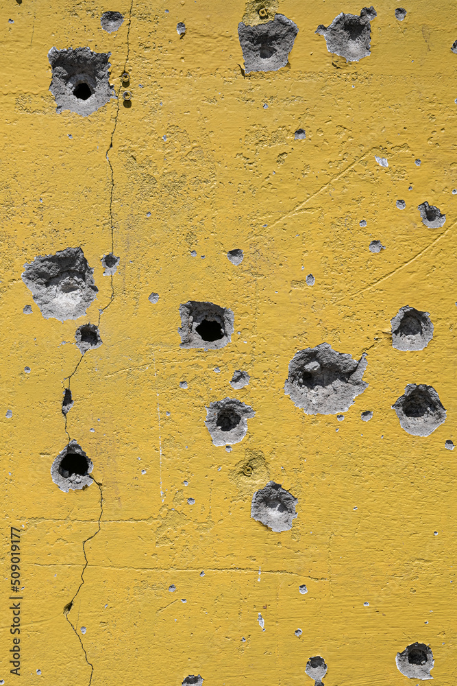 Holes from gunshots and shrapnel on a concrete wall n the war zone in ...