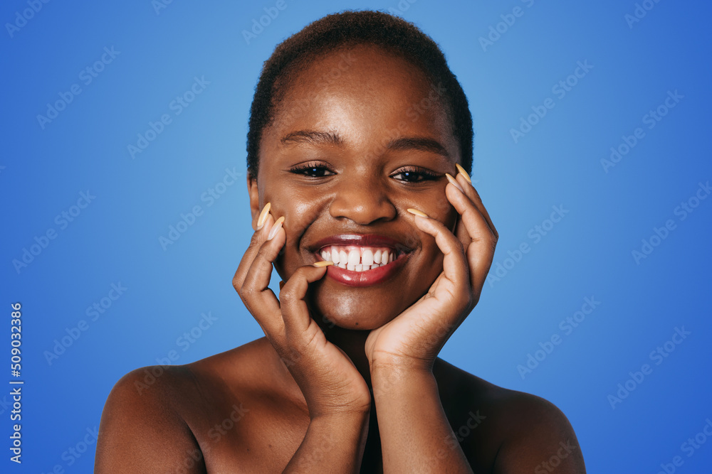 African american woman touching her perfect skin on cheeks and looking ...