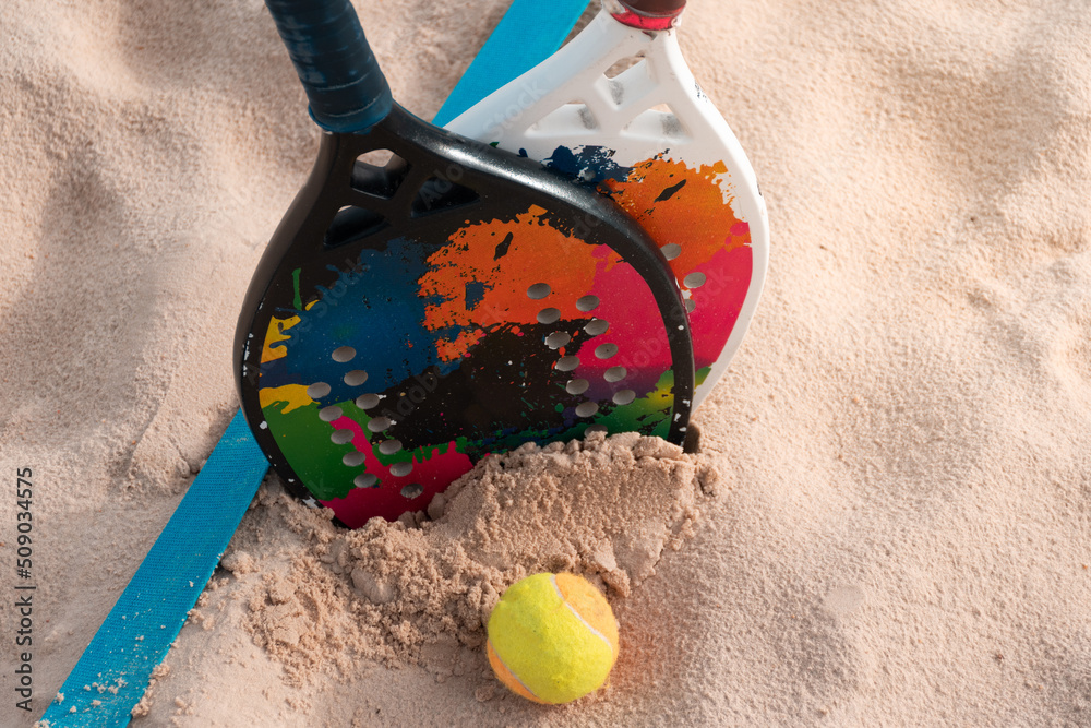 Foto de Beach tennis rackets and balls on the beach sand do Stock ...