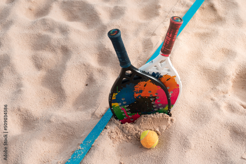 Foto de Beach tennis rackets and balls on the beach sand do Stock ...