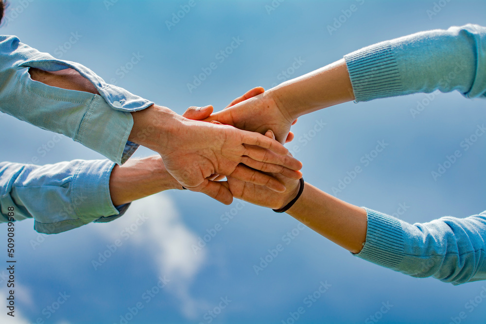 Concept of one hand over another forming a team, Concept of unity with ...