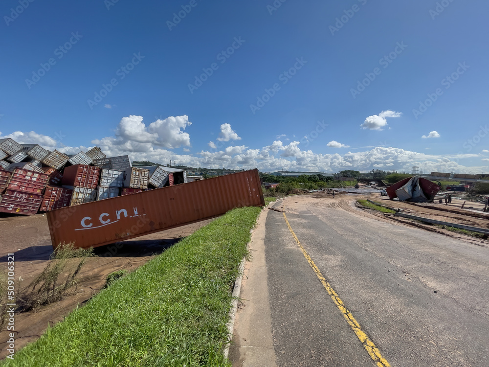 A stack of shipping containers that collapsed near a road after devastating floods in Durban ...