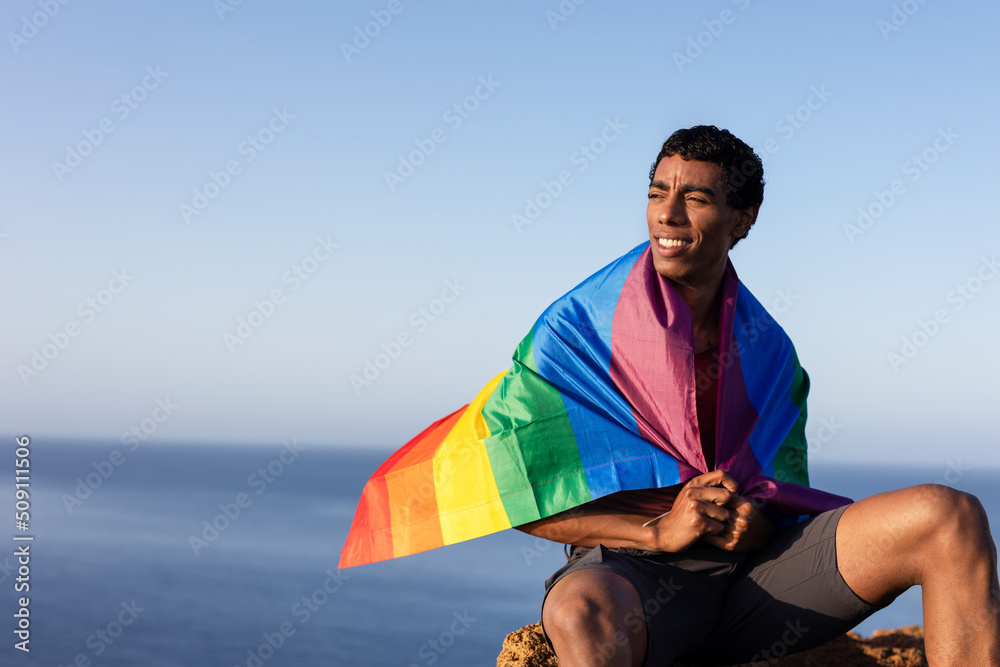Happy man with a pride flag. LGBT community Stock Photo | Adobe Stock