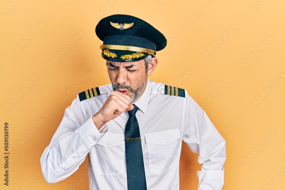 Handsome middle age man with grey hair wearing airplane pilot uniform ...