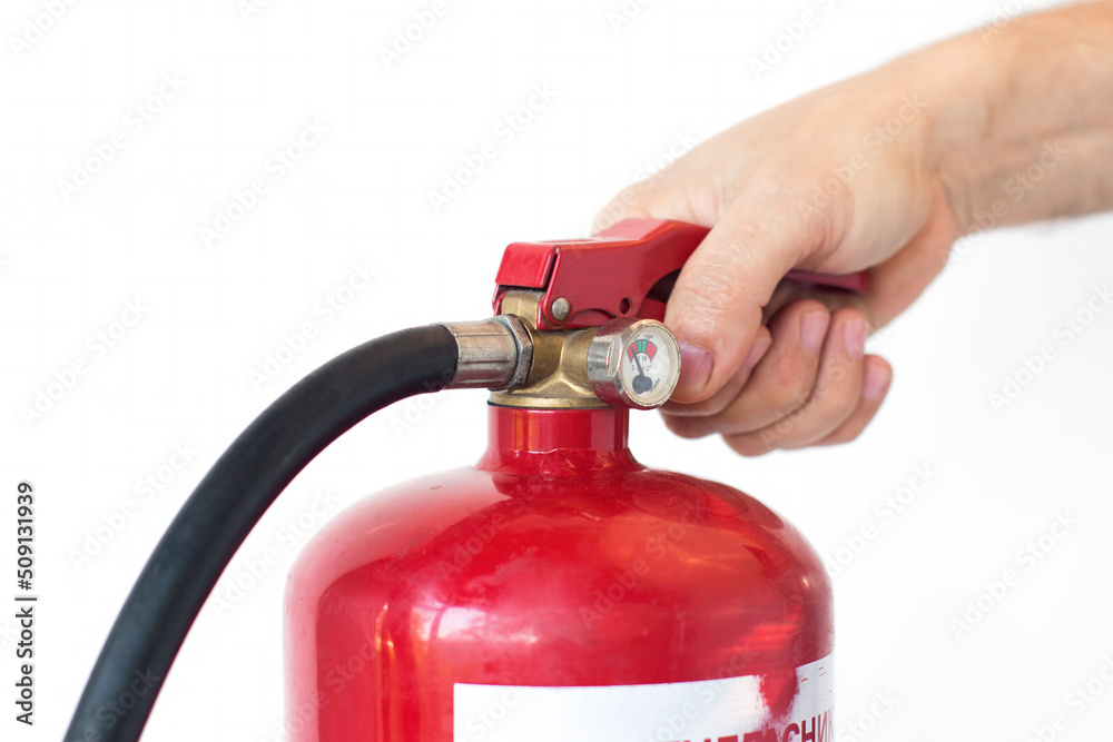 Concept of handling fire extinguishers, the hand squeezes on the fire ...