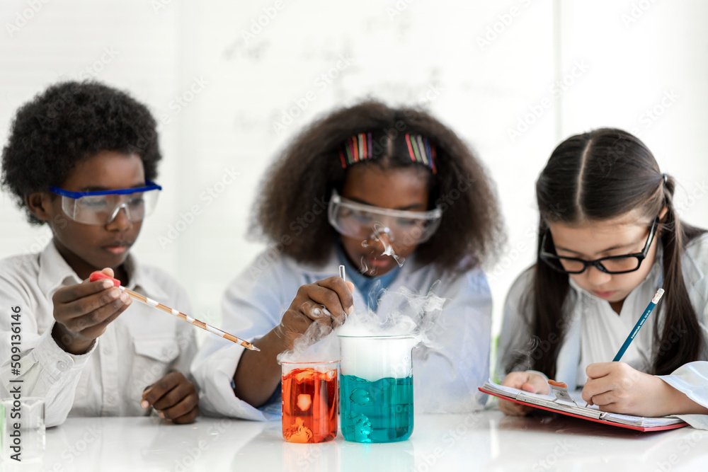 Group of teenage student learn science with teacher and study doing a ...