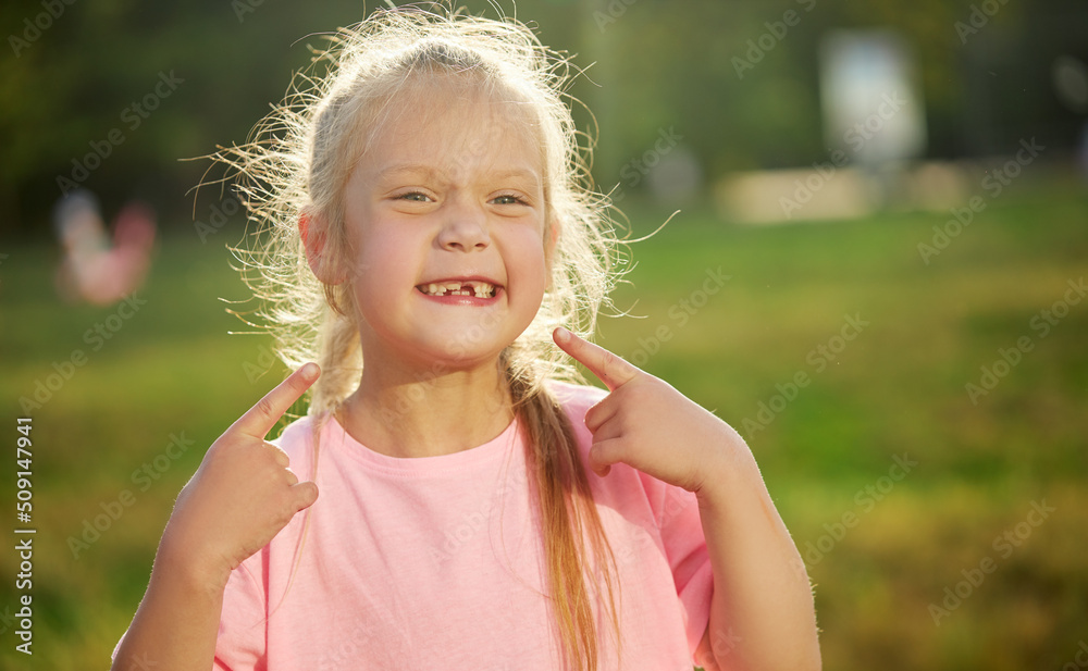 Fanny child face. Sweet little girl with a toothless smile. The first ...