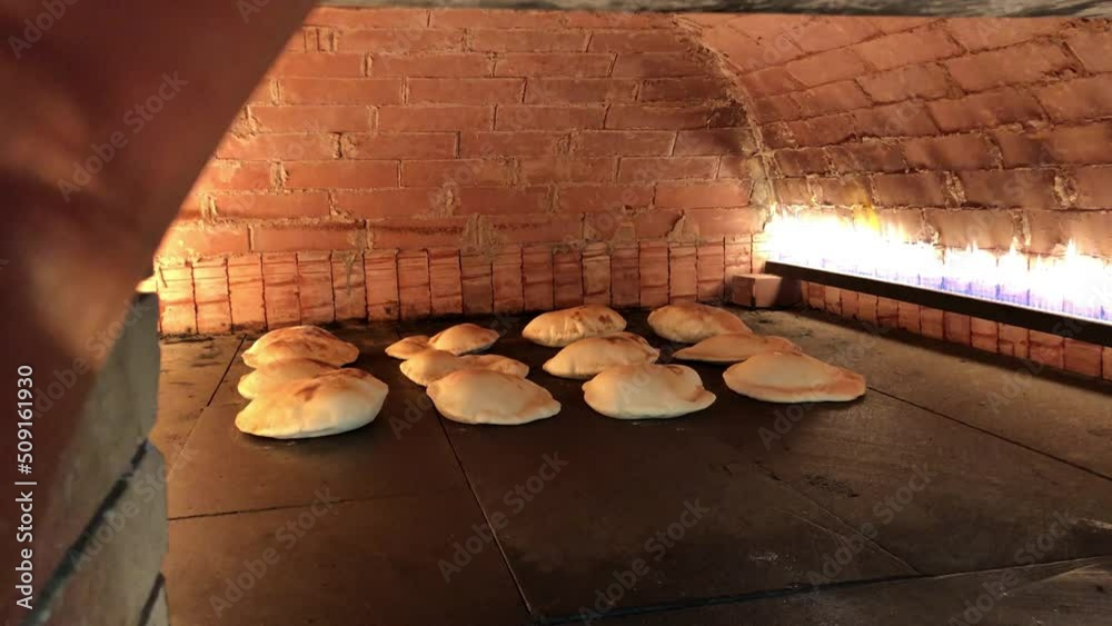 Arabic breads inside a gas arabic oven in bricks Stock-Video | Adobe Stock