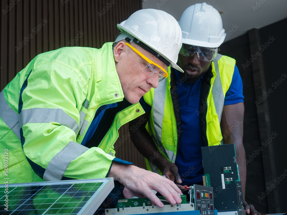 Foto de Two professional solar cell engineers wearing safety vest and ...