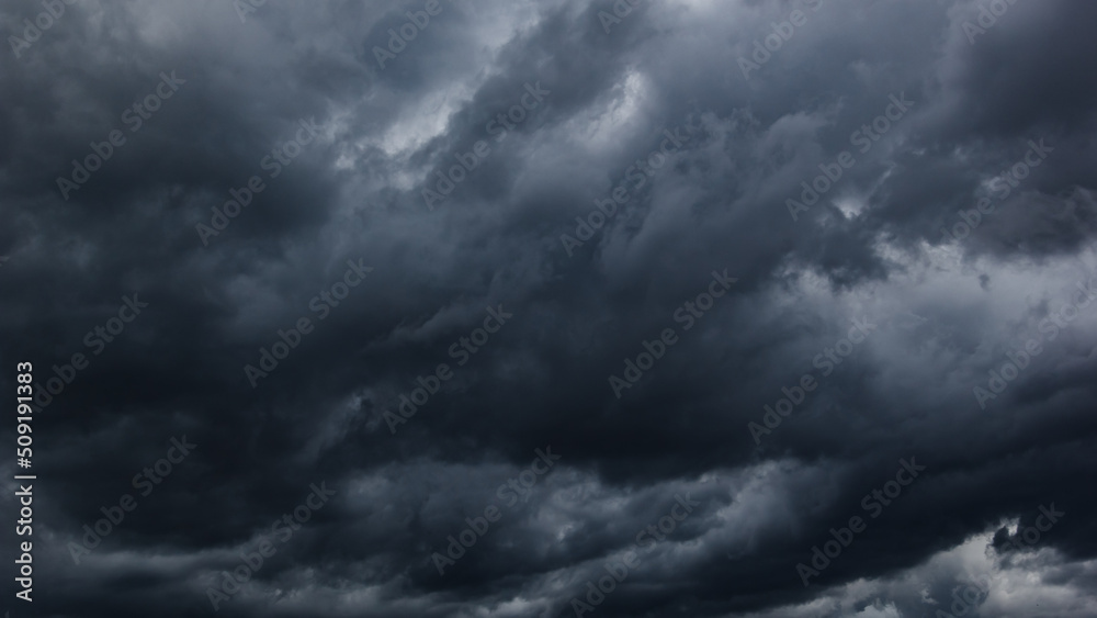 The dark sky with heavy clouds converging and a violent storm before ...