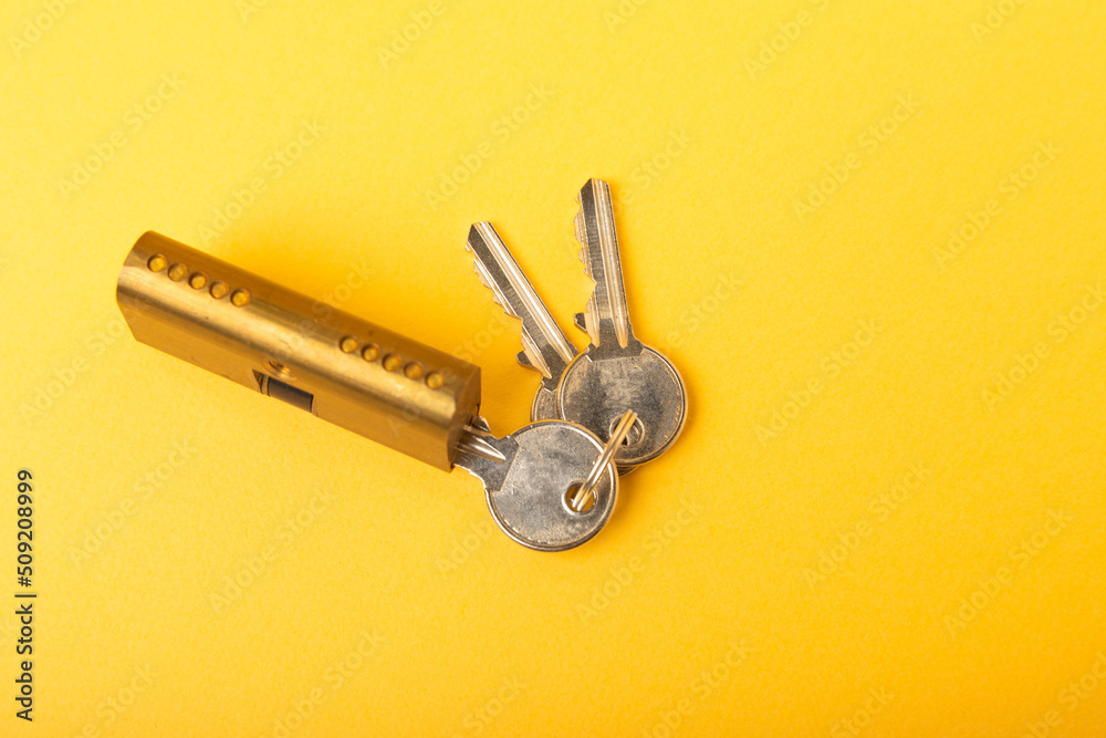 New door lock on a yellow background. Patent and keys from the front ...