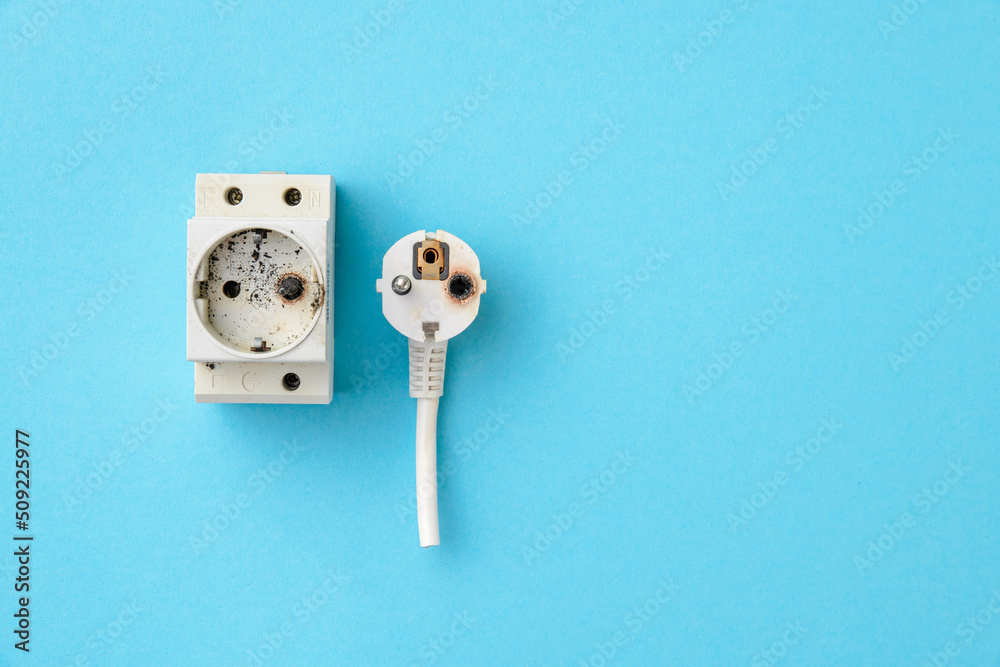 Burnt electrical wire plug and din socket after short circuit. The ...