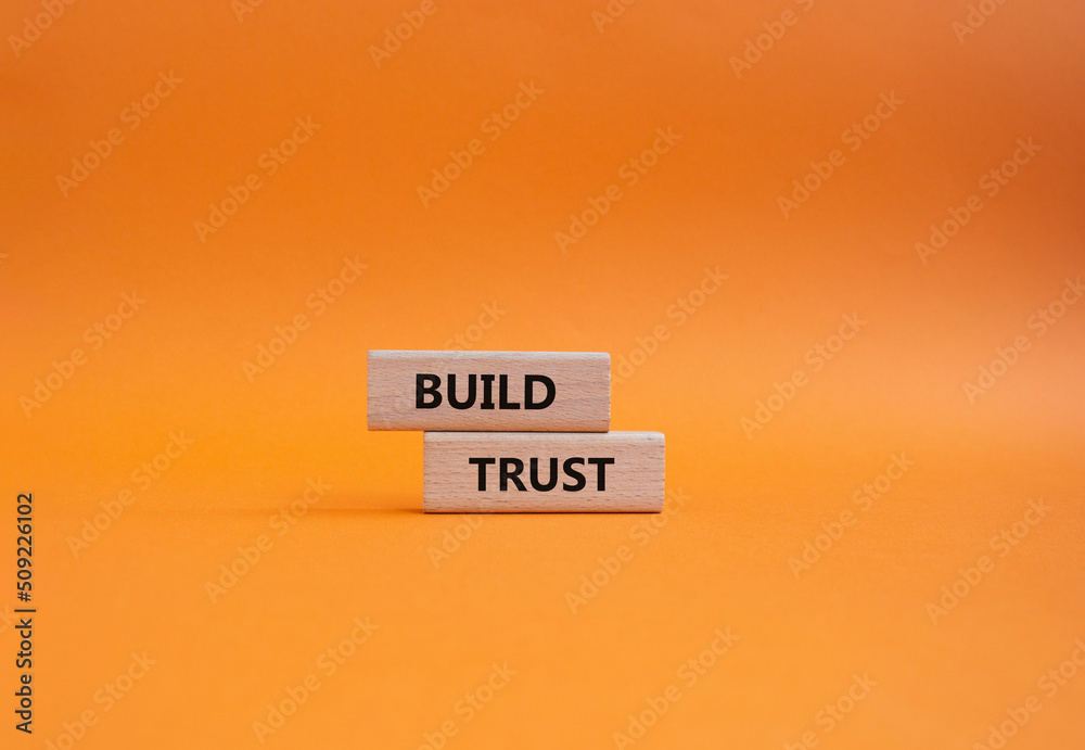 Build trust symbol. Wooden blocks with words Build trust. Beautiful ...
