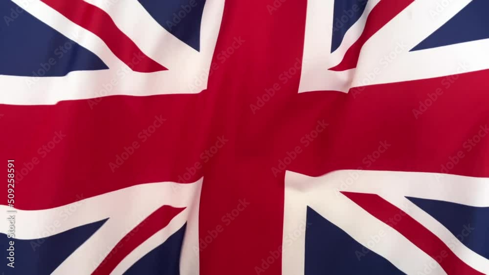 Slow motion over fabric flag of United Kingdom waving. Scrolling over ...