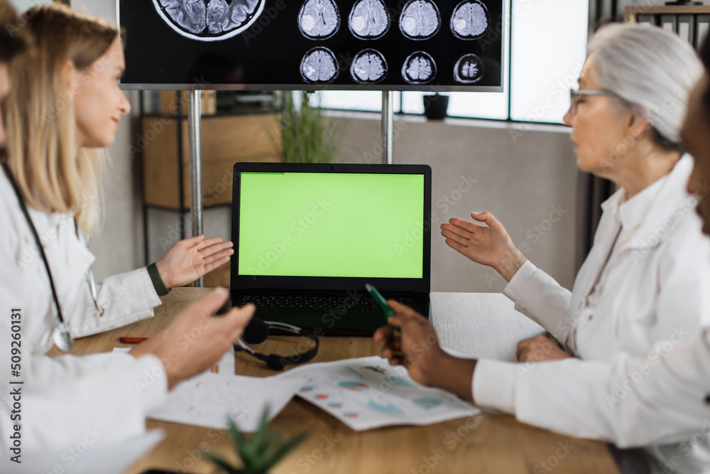 Teamwork of four multiethnic doctors wearing white lab coats and ...