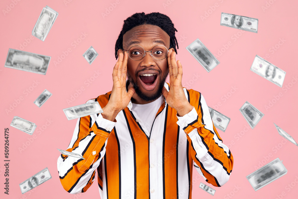 Money rain wow! Bemused surprised rich man looking at camera with ...
