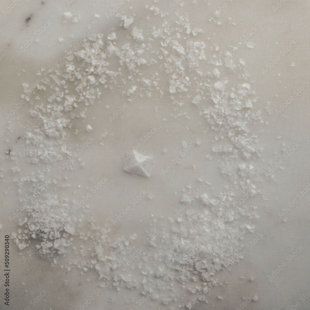 Maldon salt flakes with single pyramid shape salt crystal in center on ...