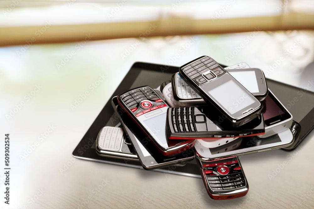 Pile of old used laptop digital tablets, smartphones for recycling on ...