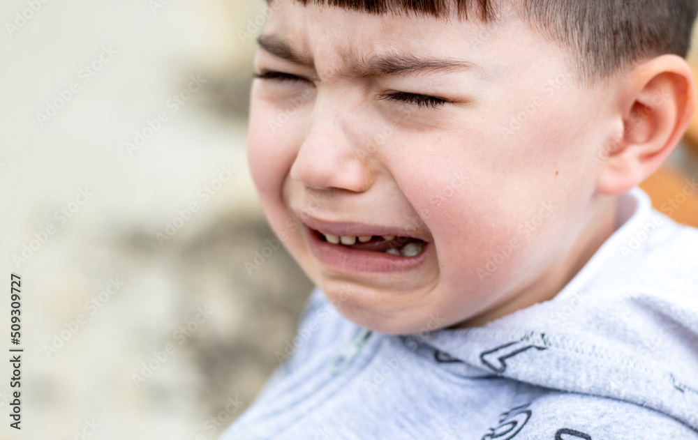 cute little boy sits at table with eco wooden colorful numbers in front ...