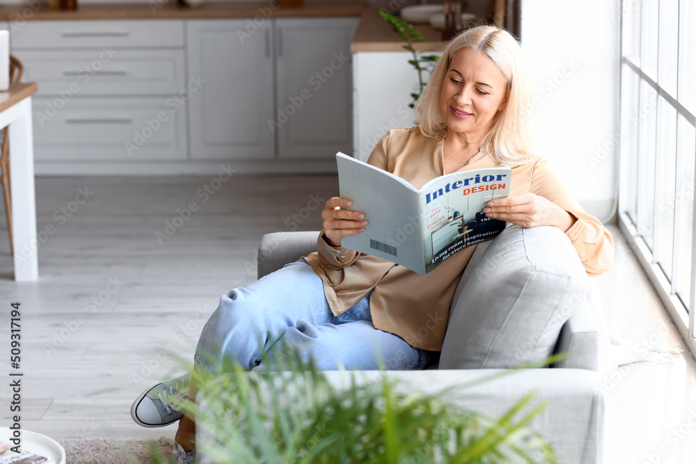 Morning of beautiful mature woman reading magazine at home Stock Photo ...