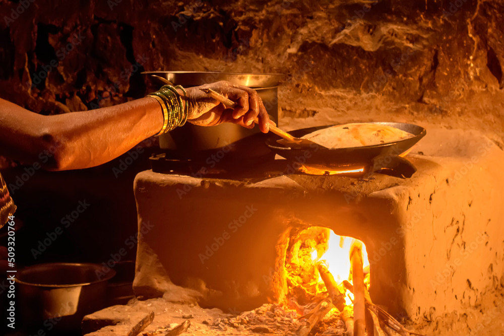 indian village woman cooking making roti bread in sitting kitchen Stock ...