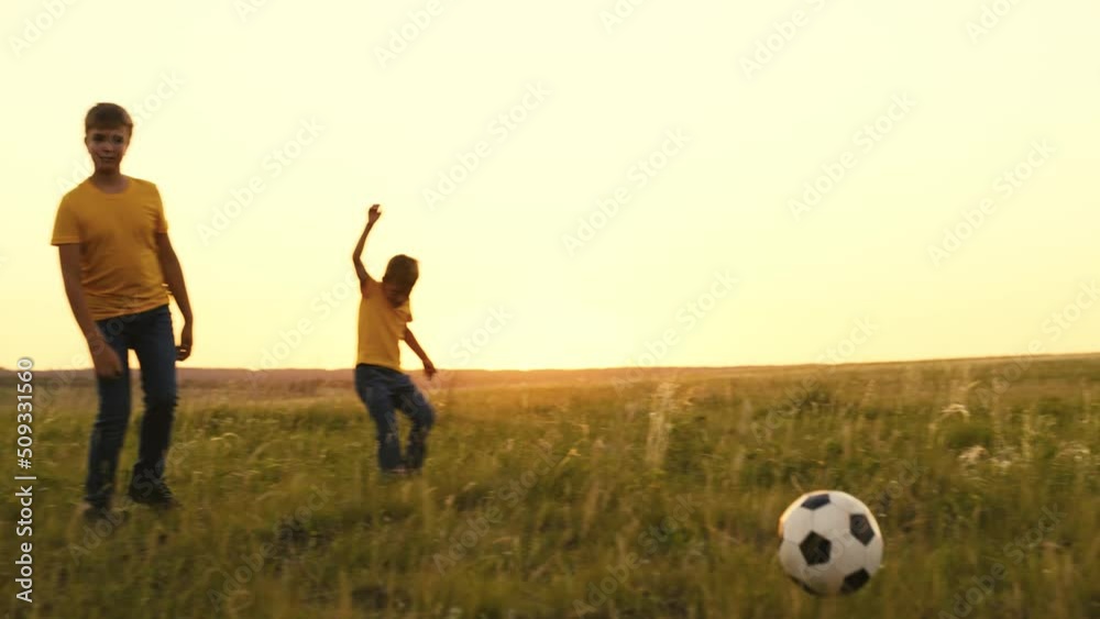 happy family sunset. group people playing soccer with soccer ball. boys ...