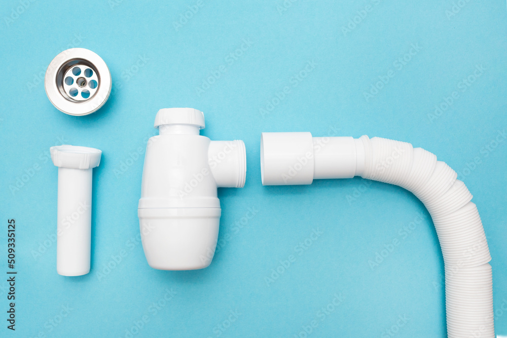Disassembled siphon for the sink on a blue background. Flat lay. Top ...