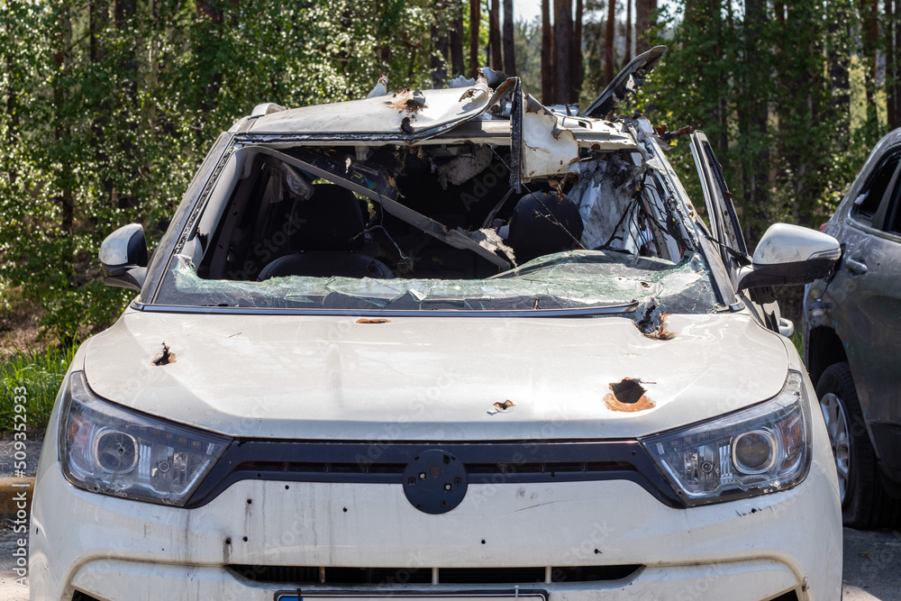 A car of civilians shot by the invaders during the war in Ukraine. Road ...