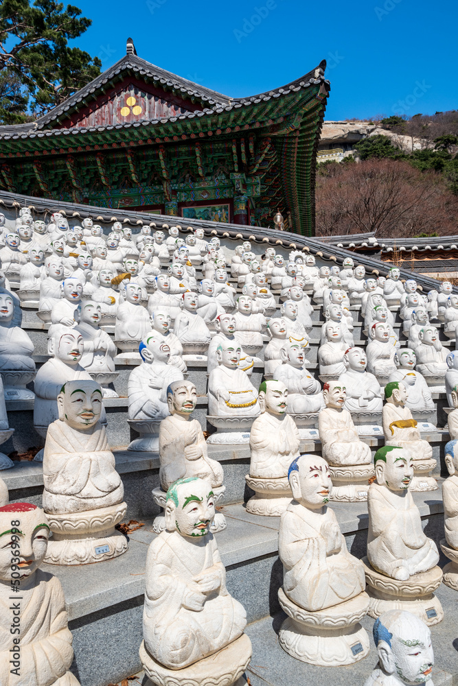Many of the 500 Buddha’s Disciples statues by a temple hall in Bomunsa ...