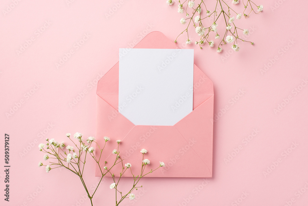 Wedding invitation concept. Top view photo of open pink envelope with paper card and white ...