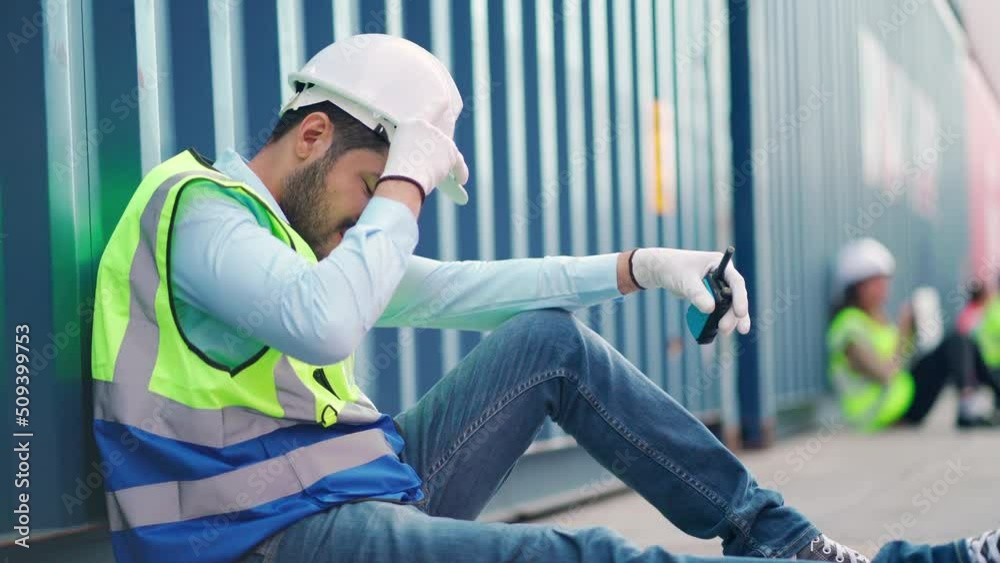 Engineer worker in safety vest sitting and rest in shipping container ...
