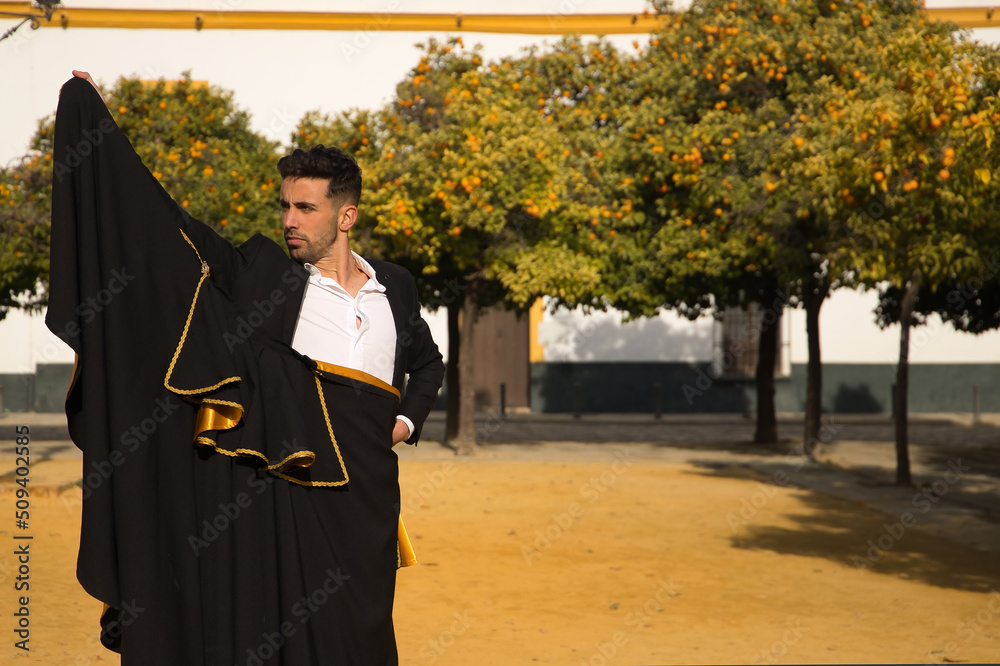 Young Spanish man in black shirt, jacket and pants, with dancing shoes ...