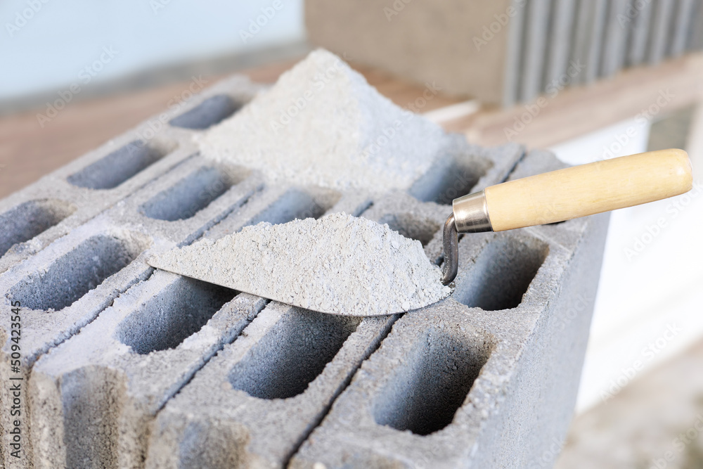 Cement or mortar, Cement mix or cement powder with a trowel put on the ...