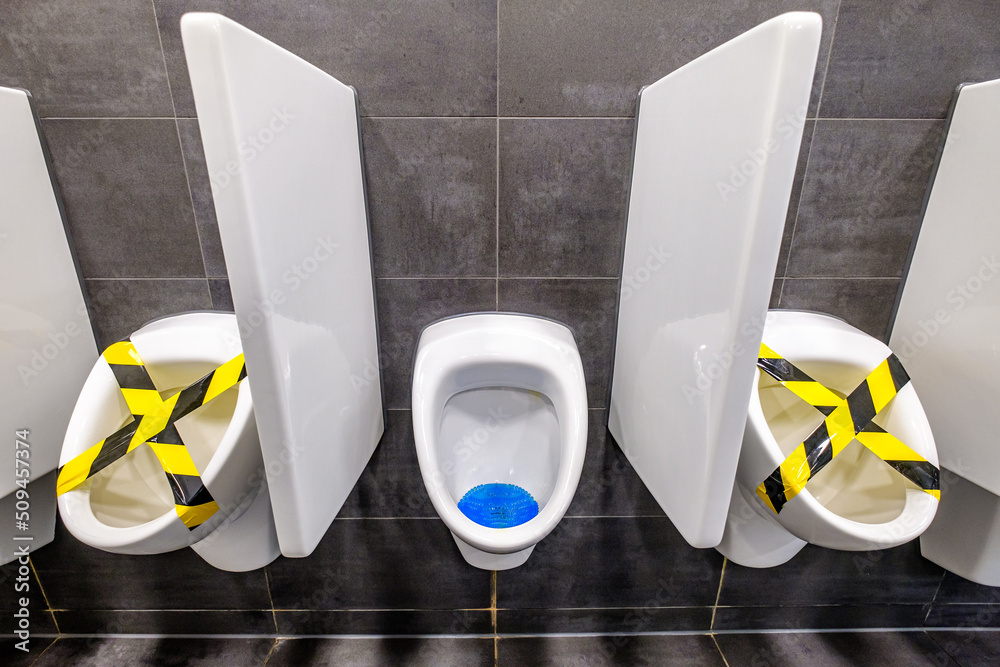 typical urinals at a public restroom Stock Photo | Adobe Stock