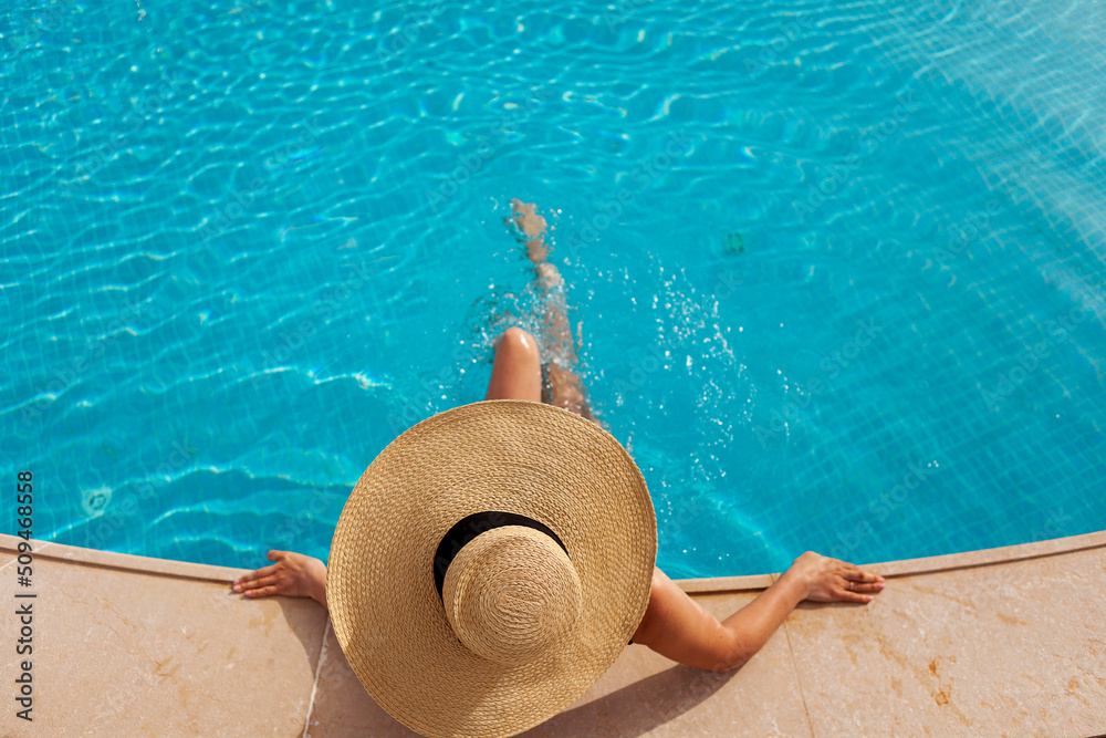 Beautiful woman sunbathing by the pool top view horizontal. Summer ...
