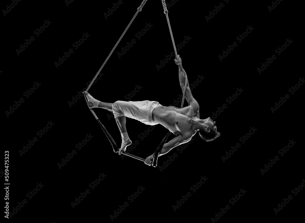 Muscular male air circus artist performances with dance trapeze Stock ...