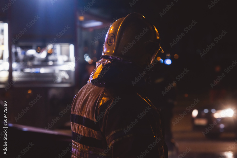 Group of fire men in uniform during fire fighting operation in the ...