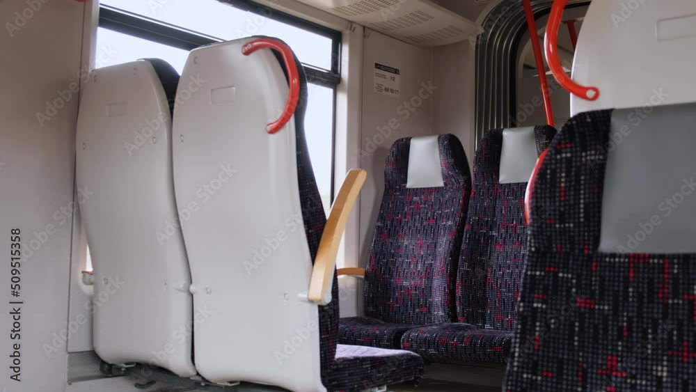 Interior view at trains empty seats window View on railroad track from ...