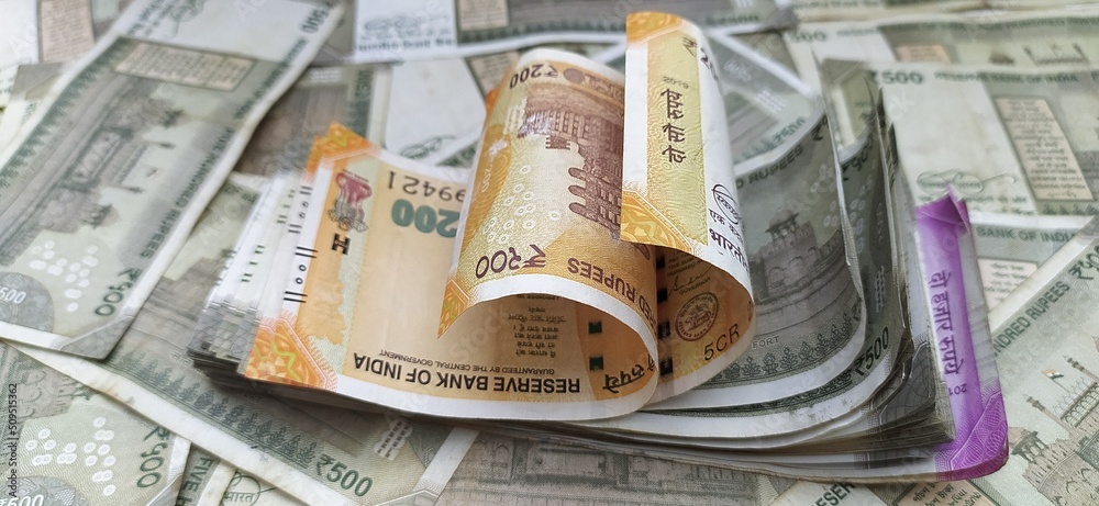 Bunch of different coloured indian currency bank notes of 200, 2000 and ...
