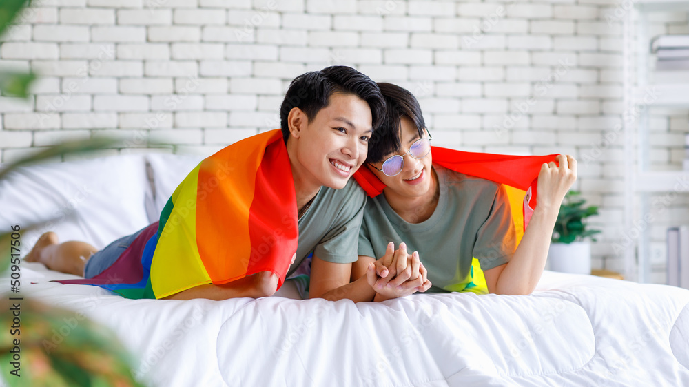 Portrait shot two Asian young lovely pride male gay men lover couple partner smiling laying down ...