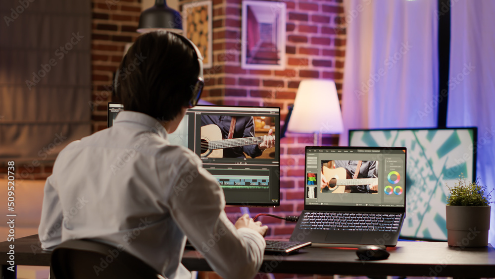 Graphic designer editing video montage on production software, working ...