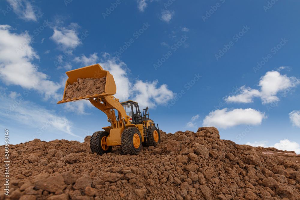 Wheel loader are digging the soil in the construction site on sky ...