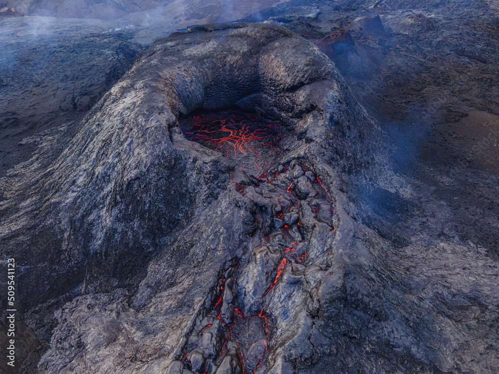 Volcano crater from above. View of the structures of red lava in the ...