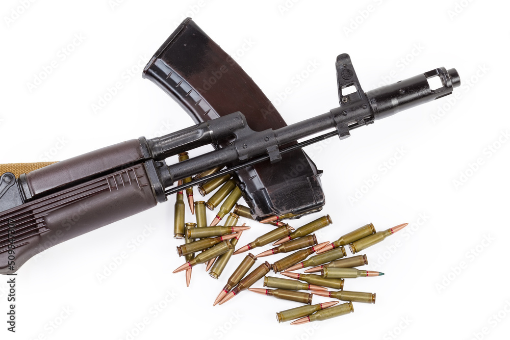 Fragment of assault rifle against rifle cartridges and loaded magazine ...