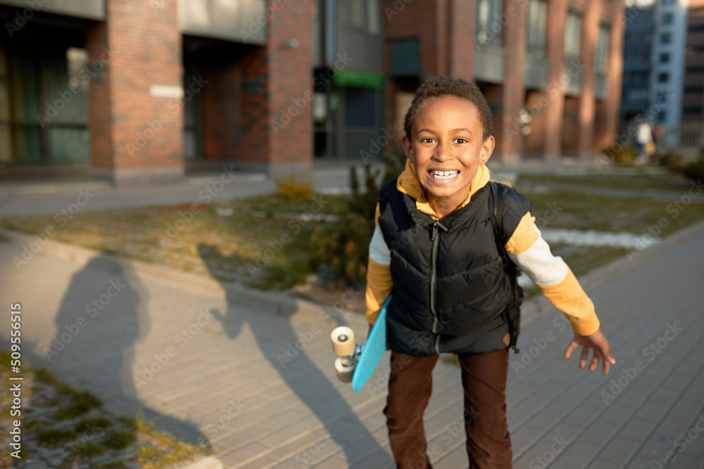 Funny happy african american kid in stylish clothes roaring at camera ...