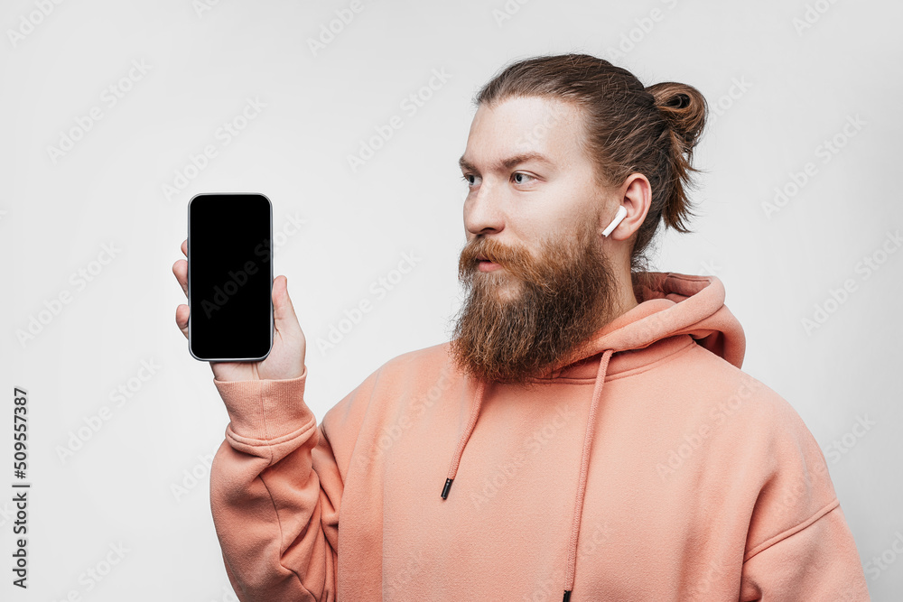 Scandinavian handsome serious man holding a phone with a black screen ...