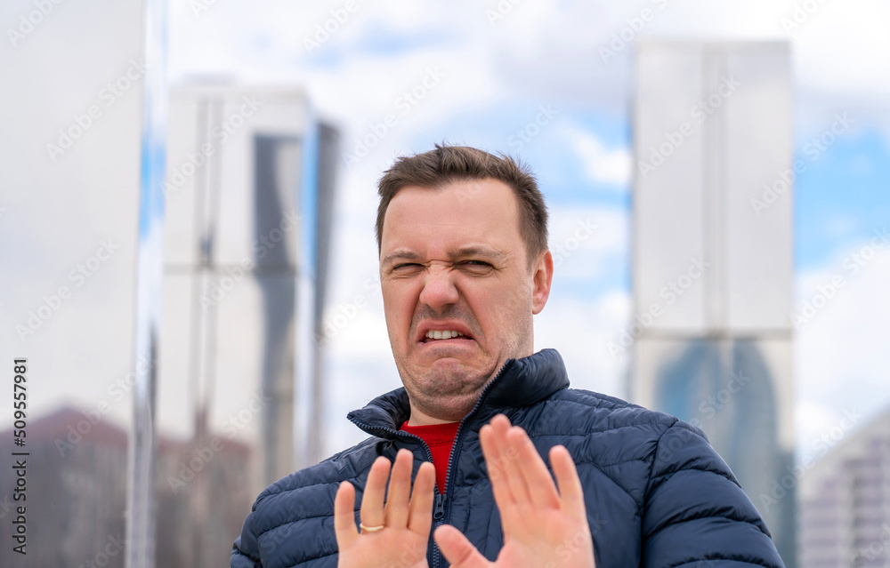 Millennial man with displeased, fearful, disgusted expression repulsing ...