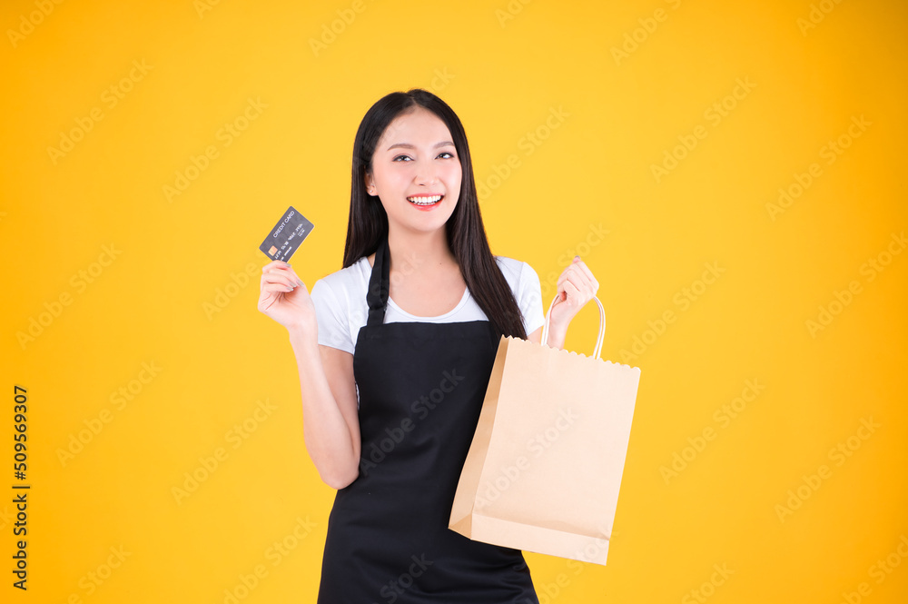asian female smile wearing black apron holding paper bag and payment ...