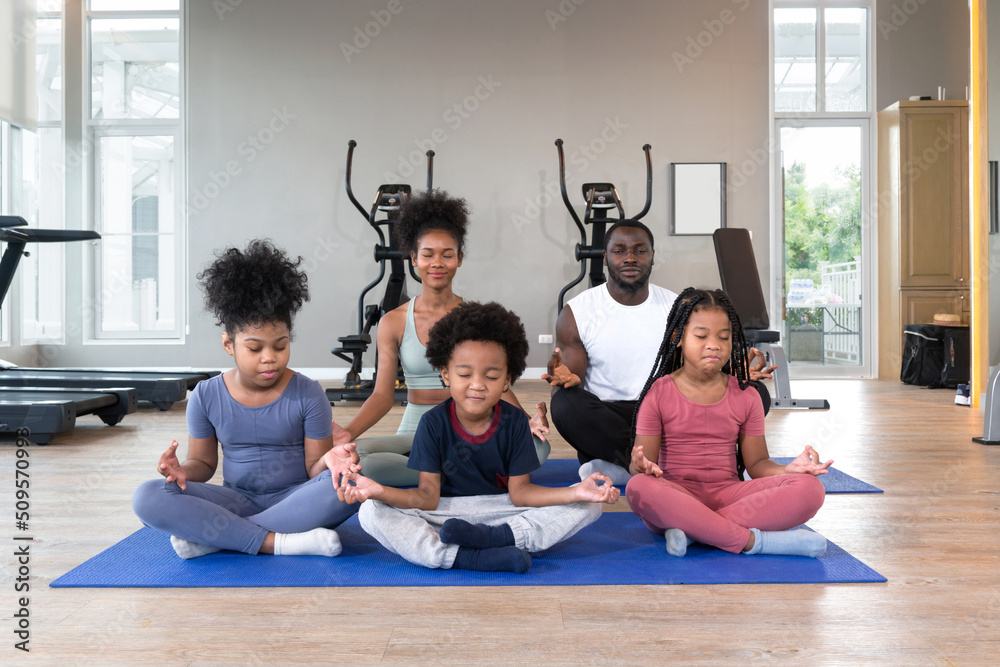 Happy family enjoy holiday together in fitness center. Meditating on ...